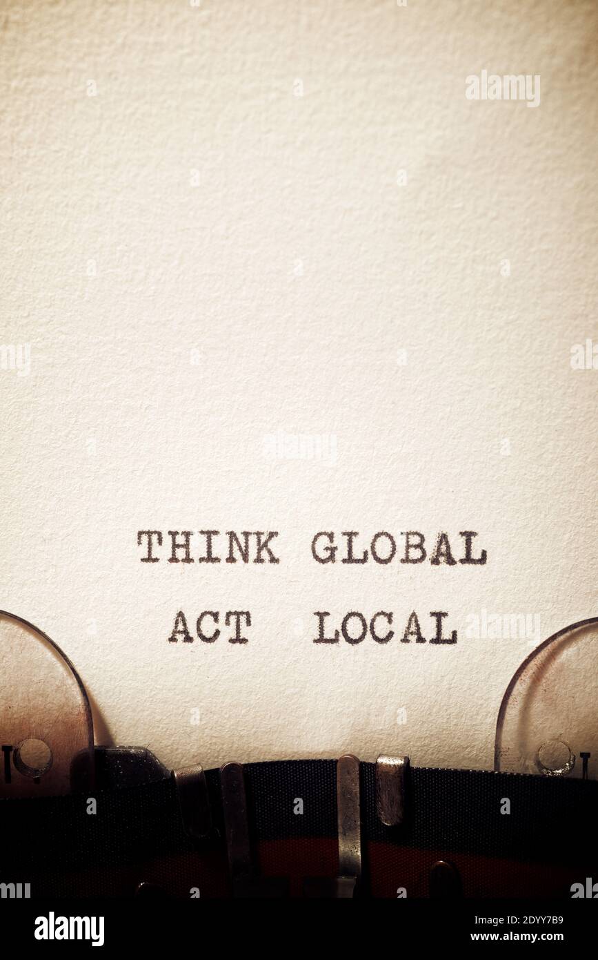 Think global act local phrase written with a typewriter Stock Photo - Alamy