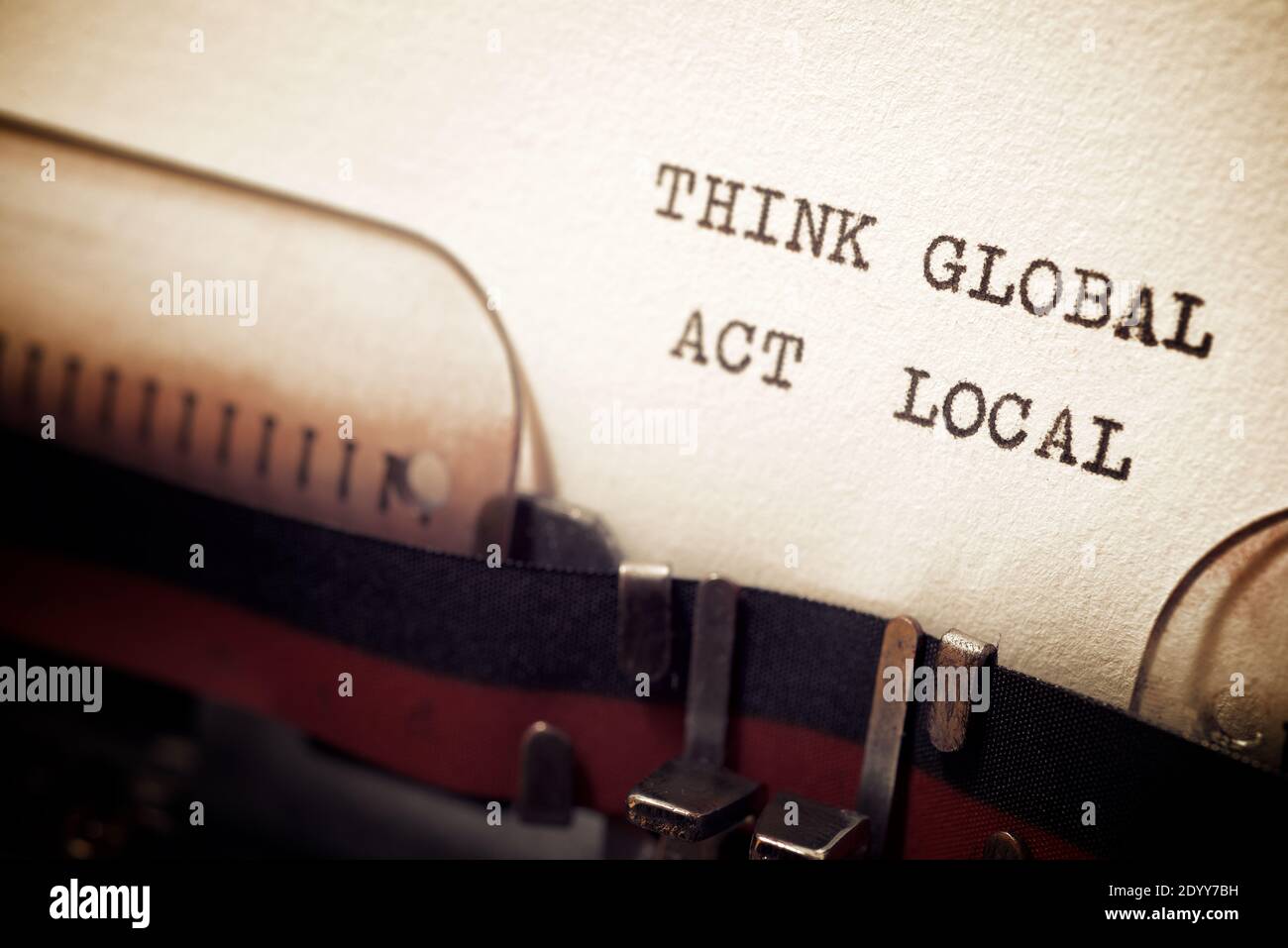 Think global act local phrase written with a typewriter Stock Photo - Alamy