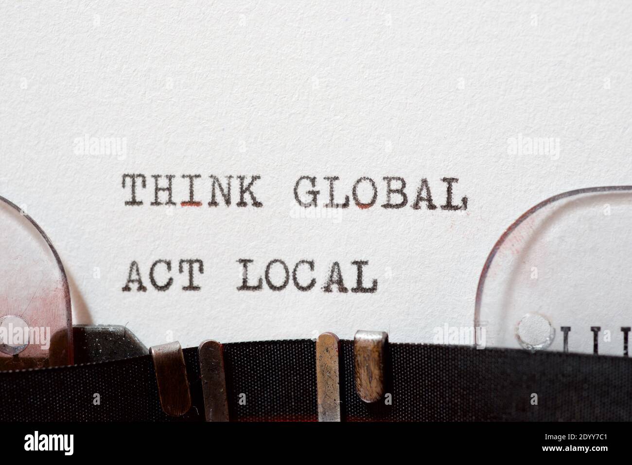 Think global act local phrase written with a typewriter Stock Photo - Alamy