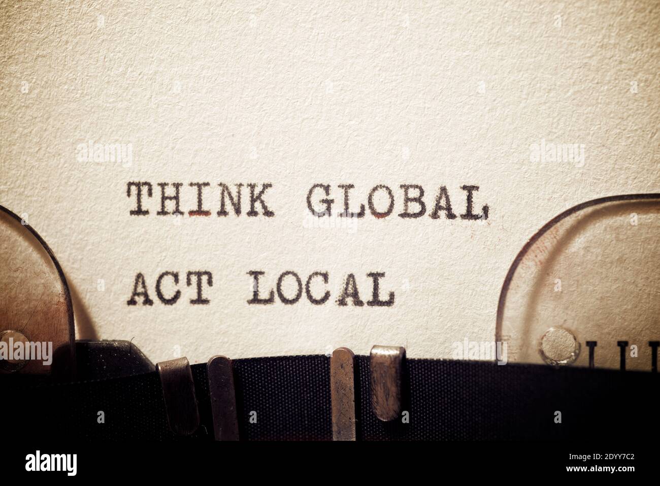 Think global act local phrase written with a typewriter Stock Photo - Alamy