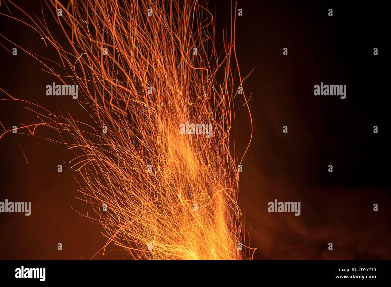 Sparks from a fire against a dark night background. Bonfire. Horizontal ...