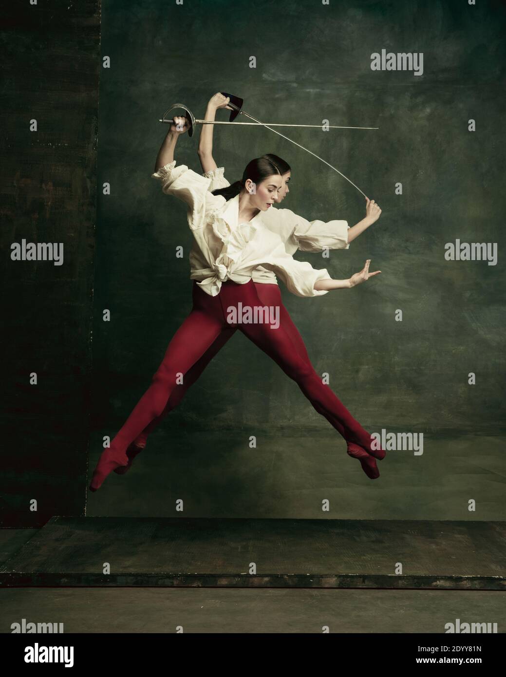 Fighting. Two young female ballet dancers like duelists with swords on ...