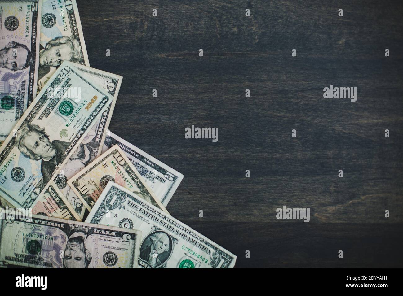 cash money bills on woodgrain Stock Photo - Alamy