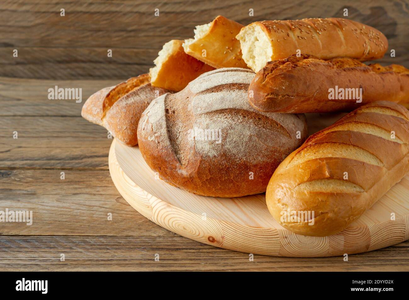 Types of homemade bread on the rustic wooden table. Homemade baked ...