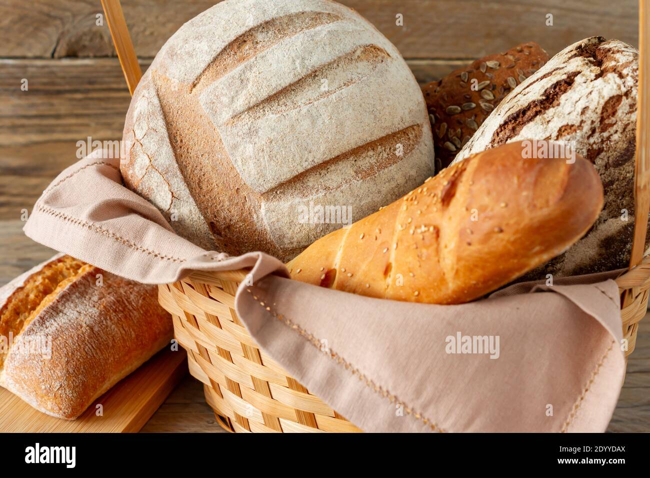 Composition of various baked products in basket on rustic background ...