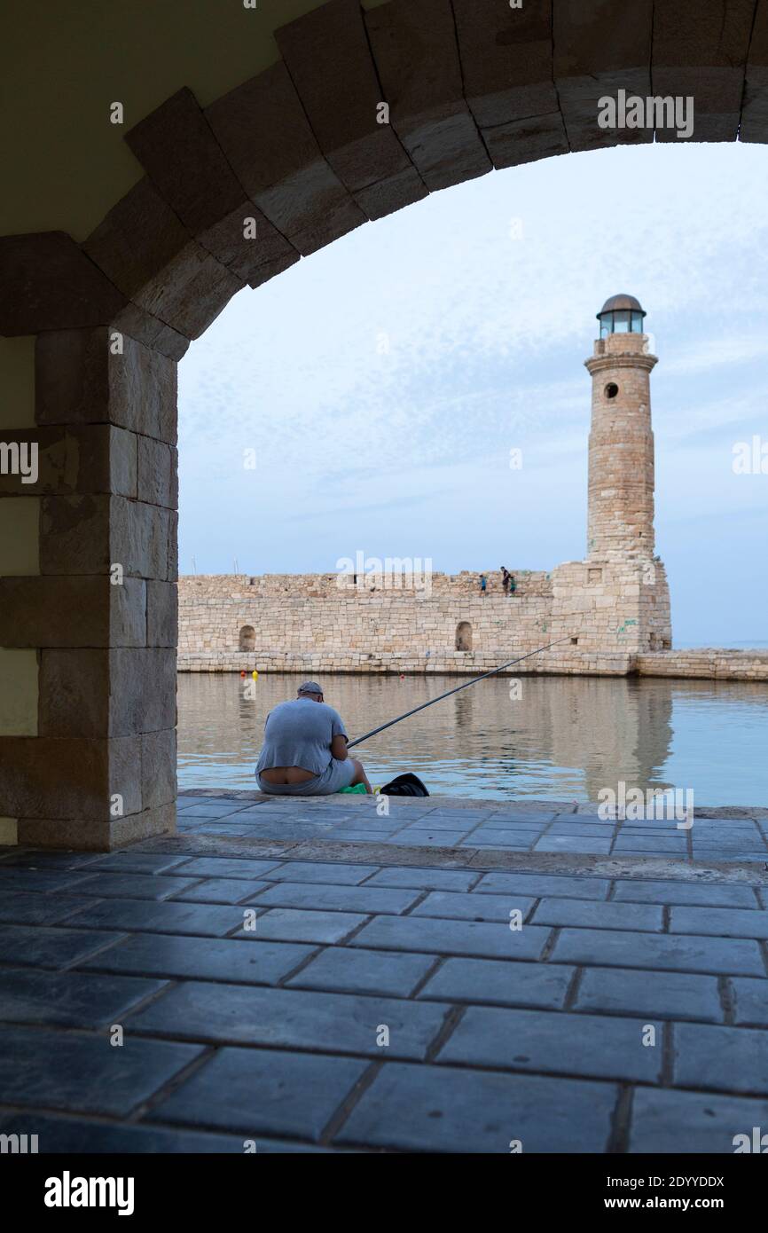 A local man fishing in front of the lighthouse at the Old Venetian ...