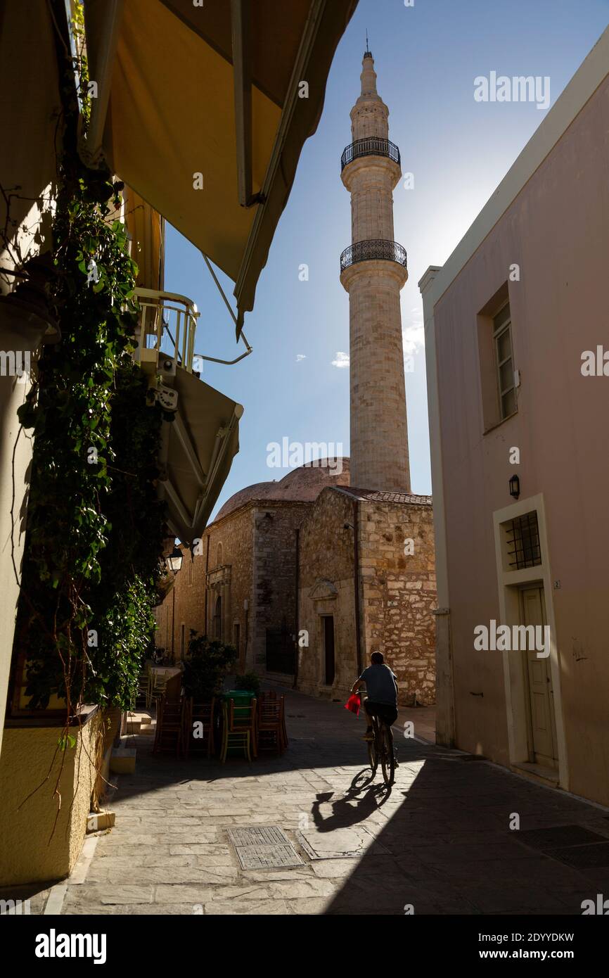 A person on a bicycle riding past the minaret of Neratze Mosque ...