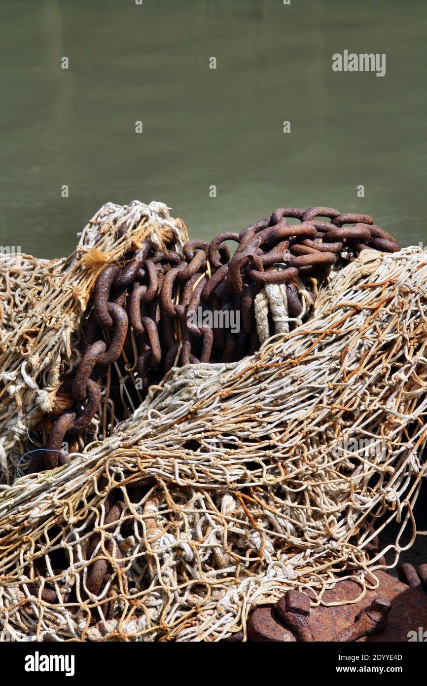 Fishing net and anchor chain - harbour Stock Photo - Alamy