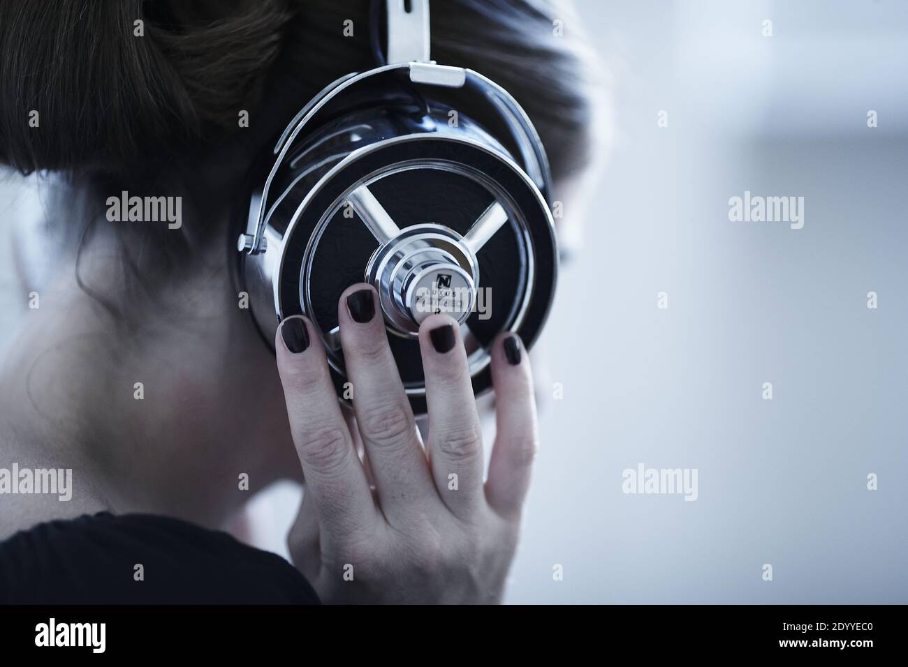 Back view of woman with vintage headphones white background Stock Photo ...