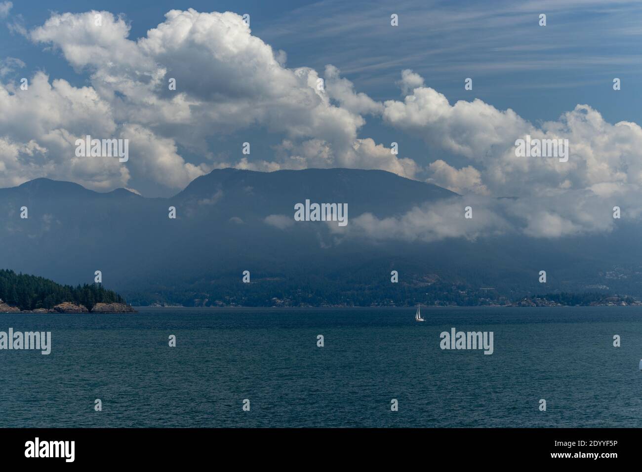 Coastal mountains almost hidden behind the clouds on the Pacific Ocean ...
