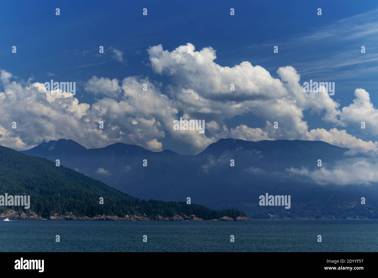 Coastal Pacific mountains as viewed from the Thick white clouds drift ...