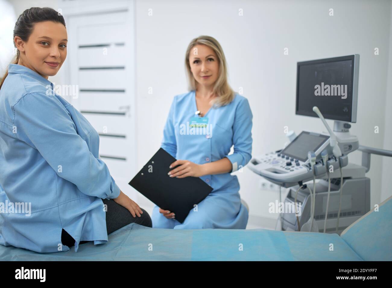 Female gynecologist with blond hair providing professional treatment ...