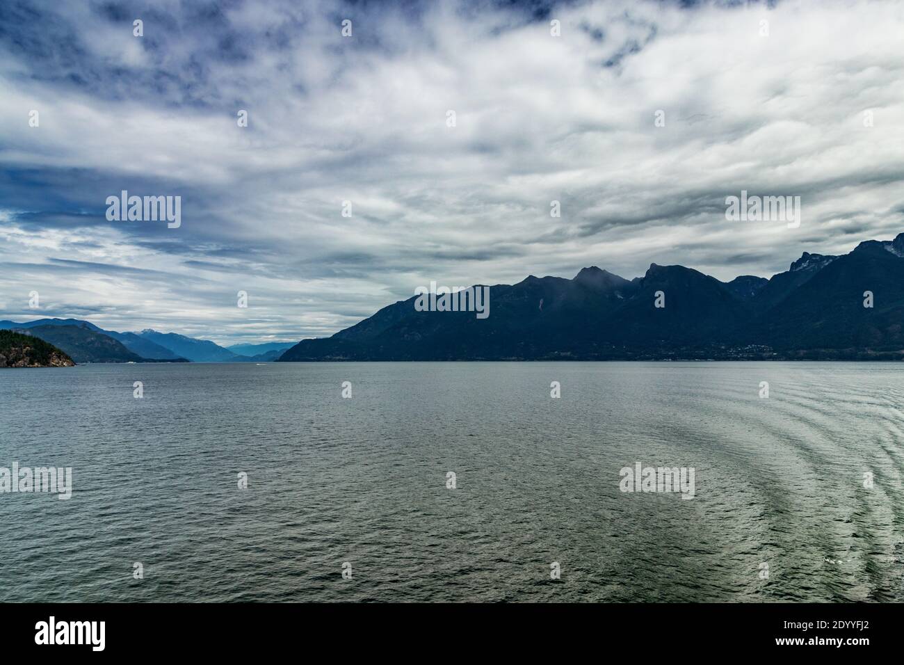 Ocean scenery with mountains and lush forests off Pacific Ocean, BC ...