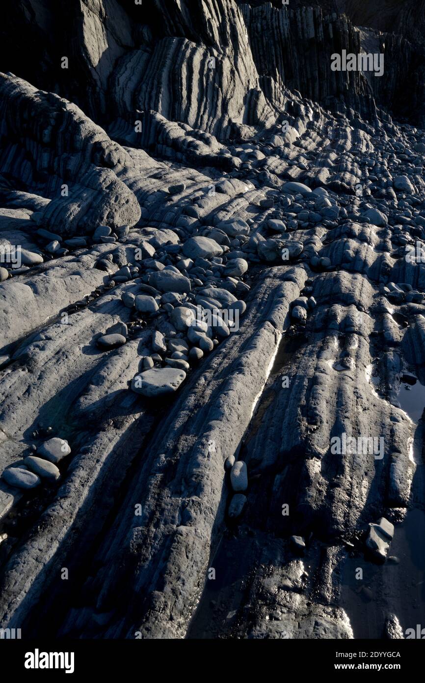 Beach by cliff coastal path with pebbles,rocks and unique stacked ...
