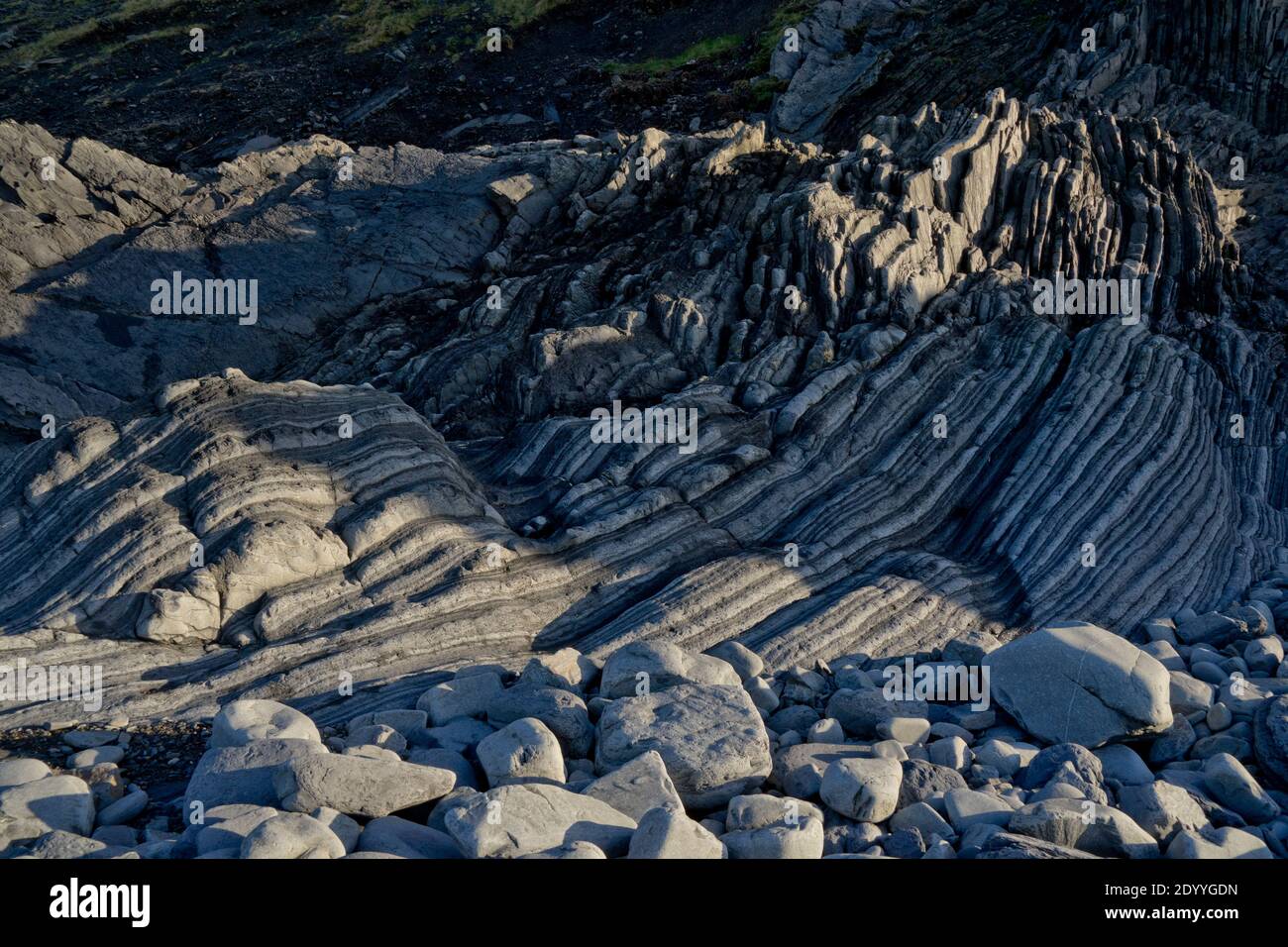 Beach by cliff coastal path with pebbles,rocks and unique stacked ...