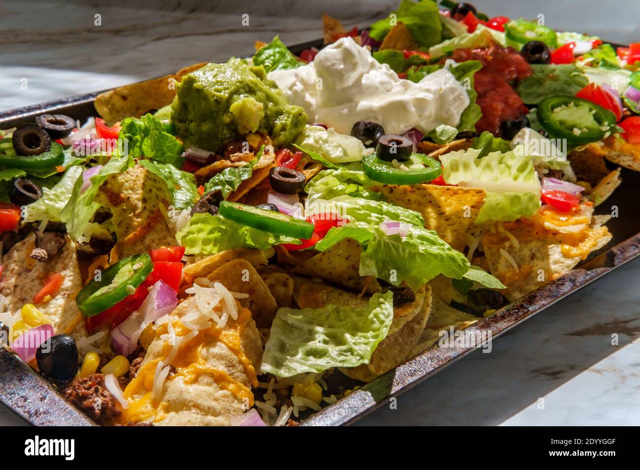 Loaded toppings beef nachos with guacamole sour cream and tomato salsa ...