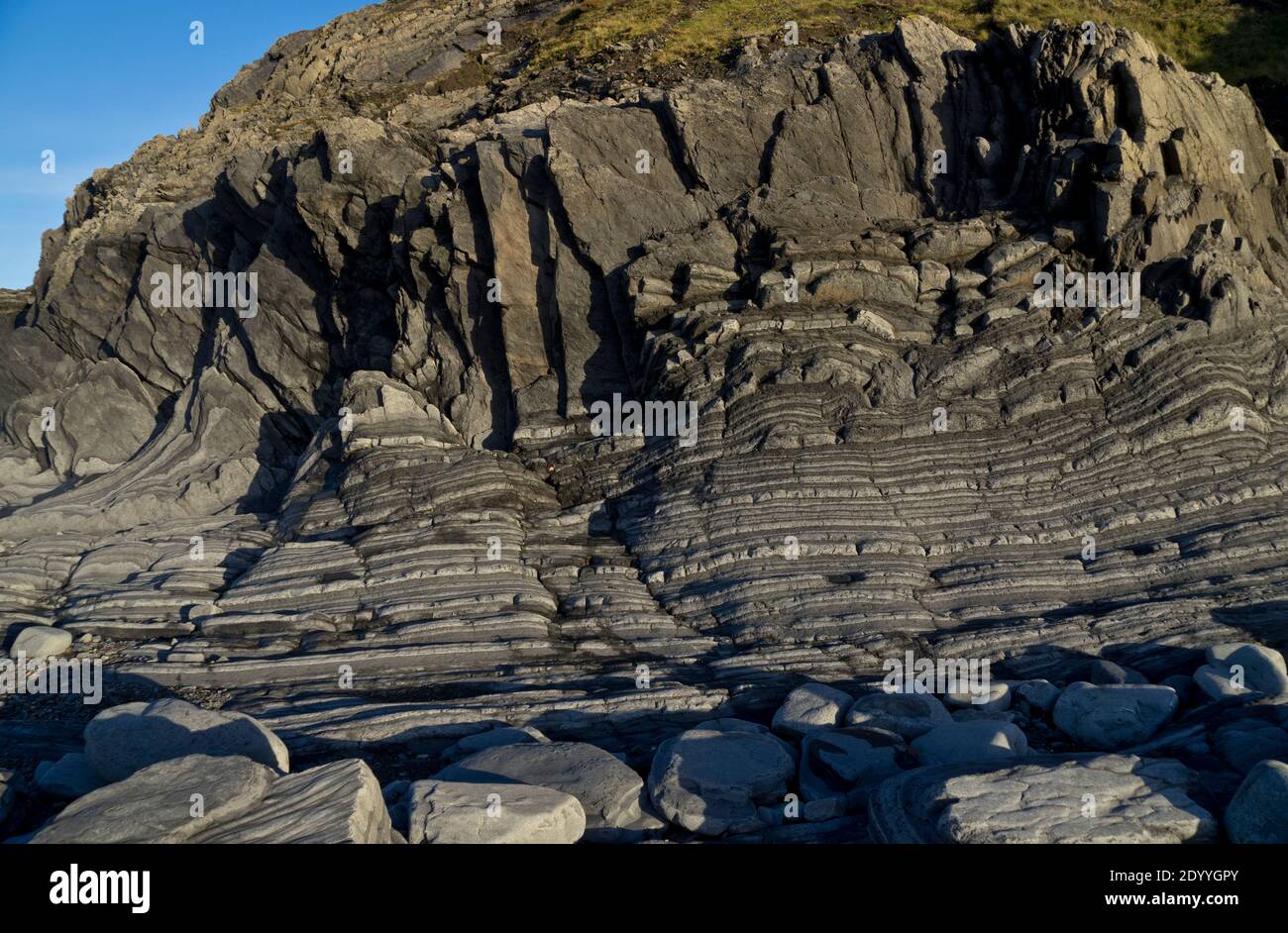 Beach by cliff coastal path with pebbles,rocks and unique stacked ...