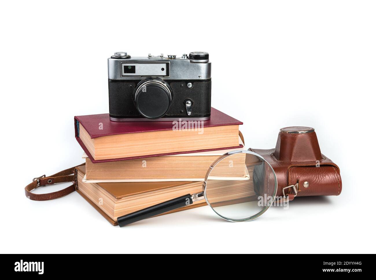 Vintage camera, books and magnifier isolated on white background Stock ...