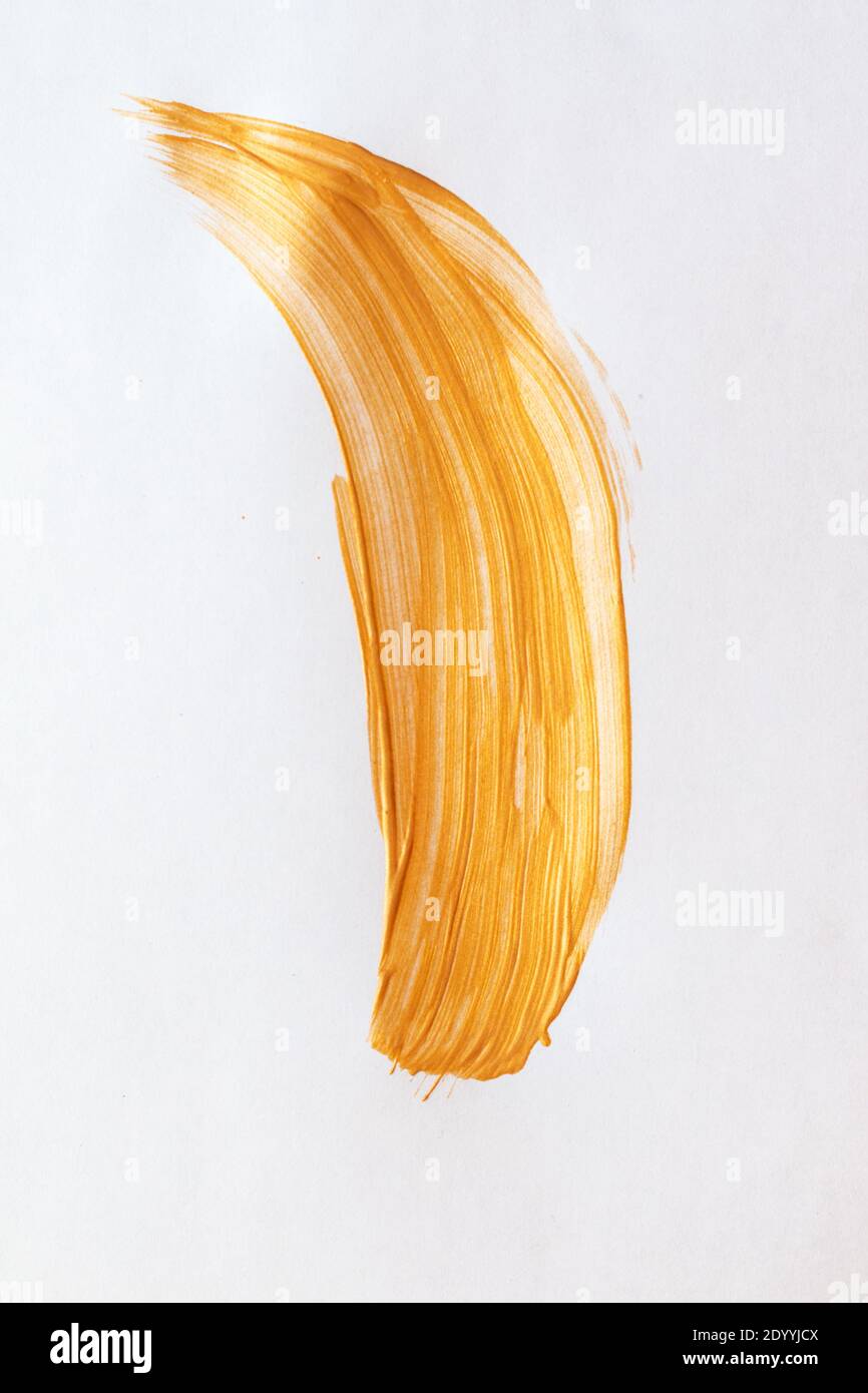 sample brushstroke of golden paint on white background Stock Photo - Alamy