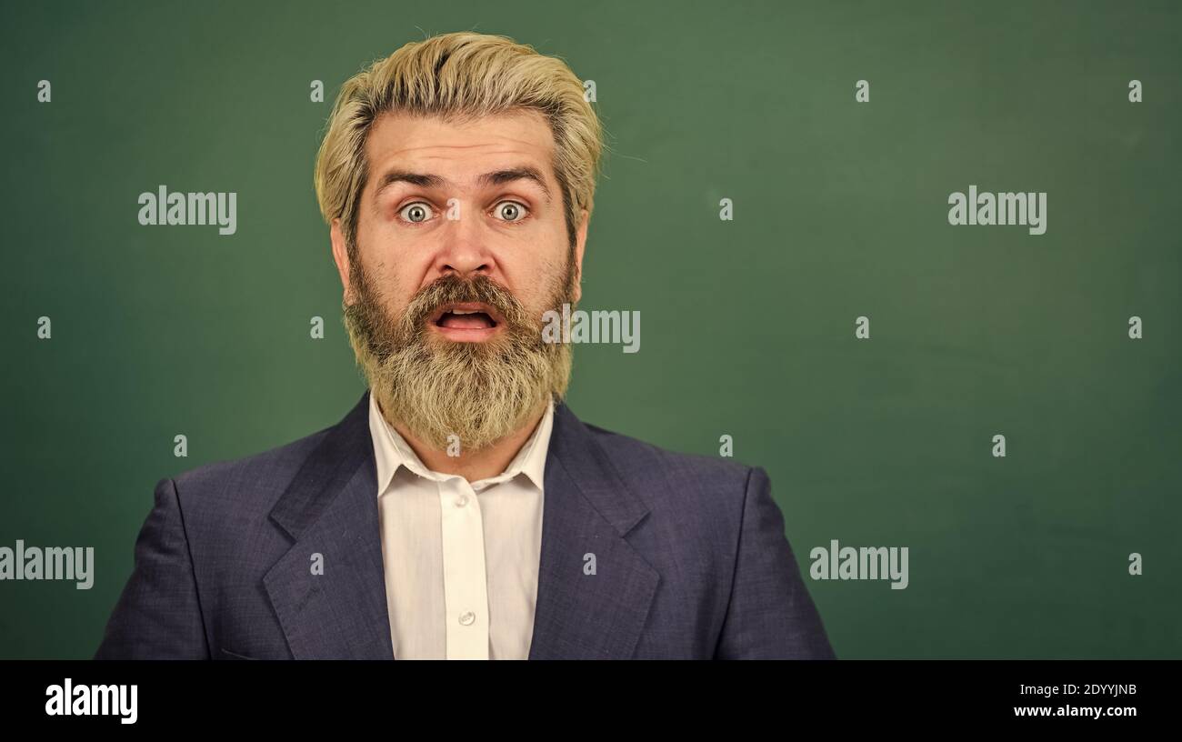 Teaching for surprise. Surprised teacher at green chalkboard. Bearded ...