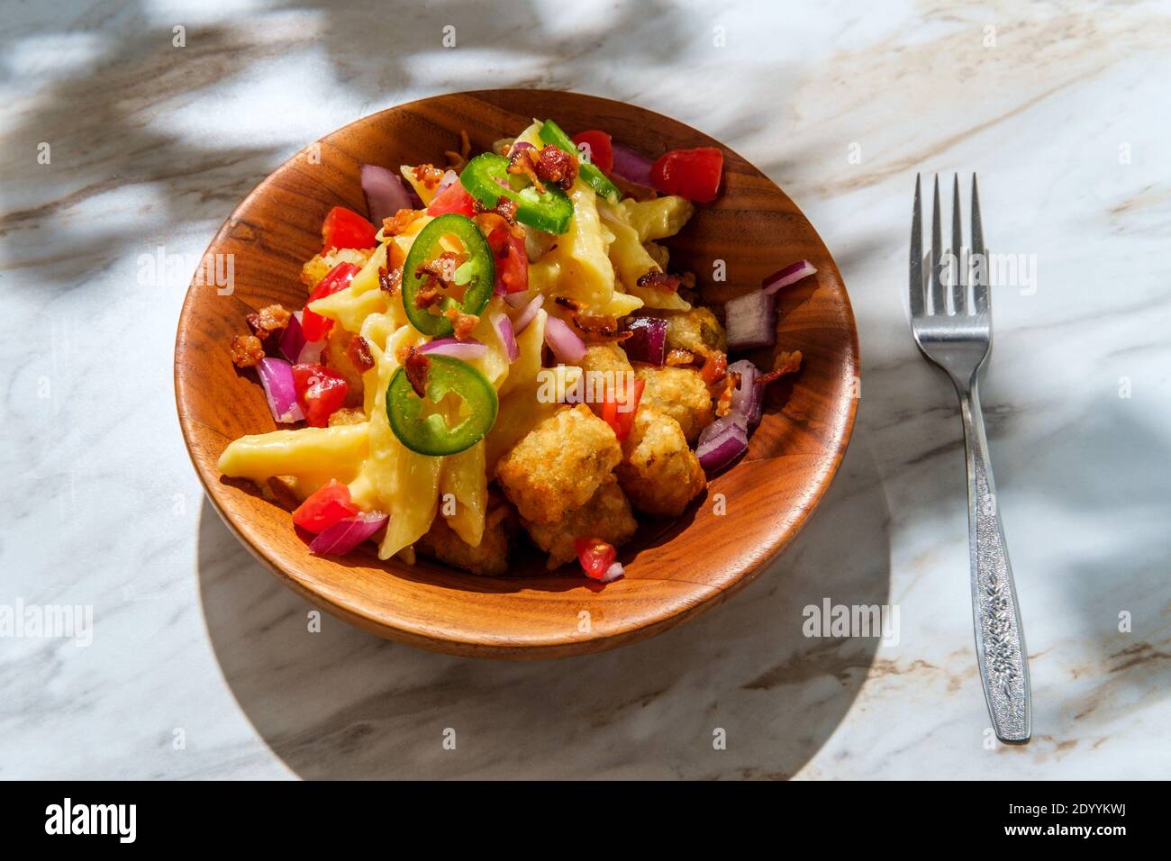 Fancy gourmet tater tot mac and cheese penne pasta topped with diced ...