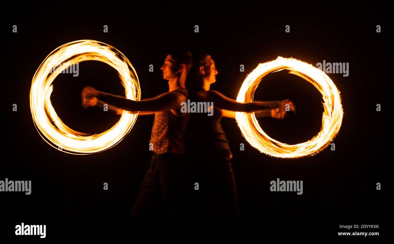 Creating awesome tracer effects. Couple of artists perform fire ...