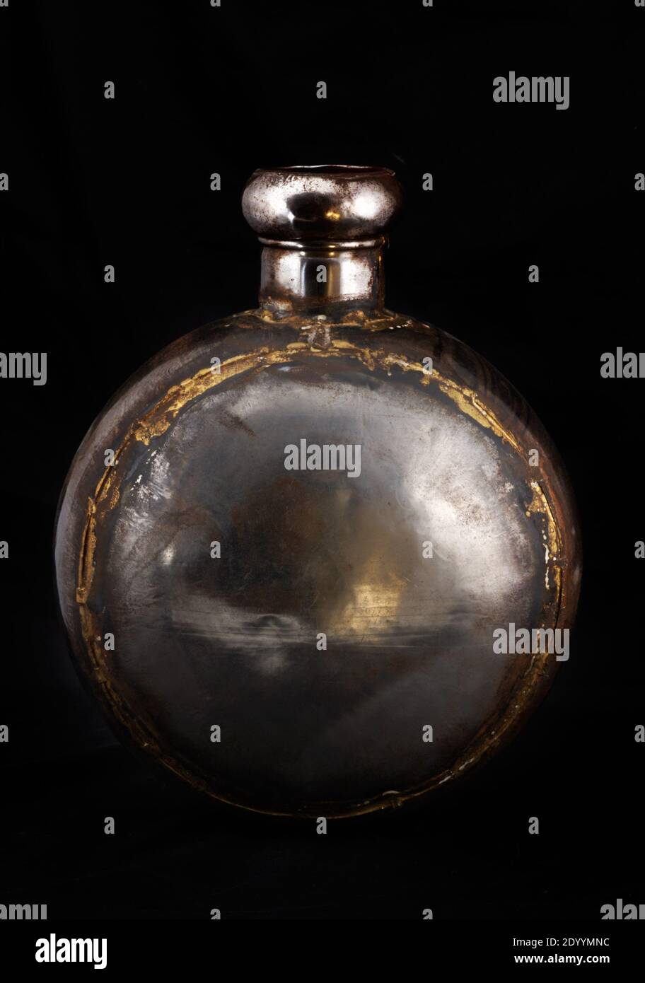 Oriental old welded metal flask, rusty and used, on black background ...