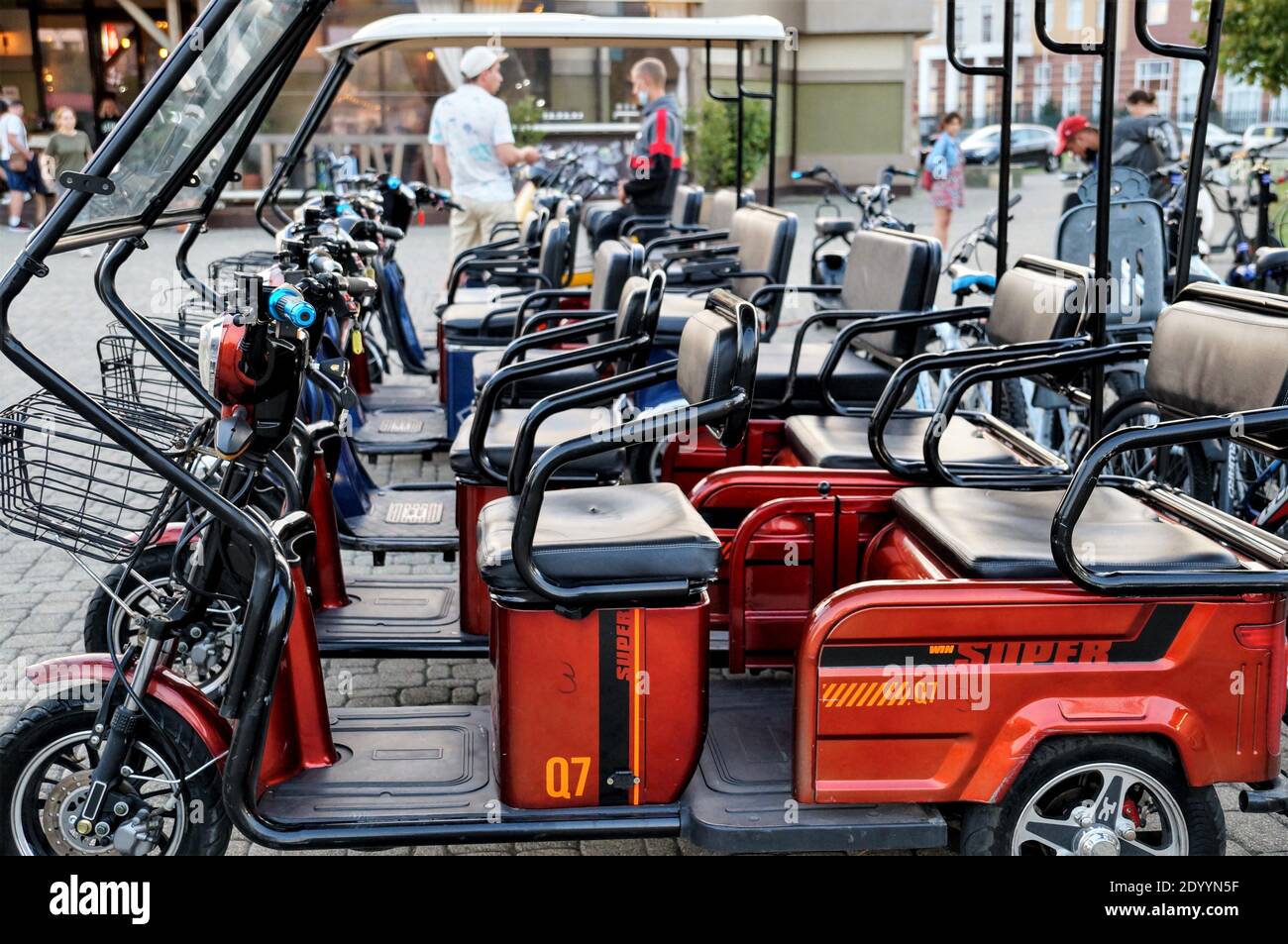parking lot of red electric mini-touring vehicles Stock Photo - Alamy