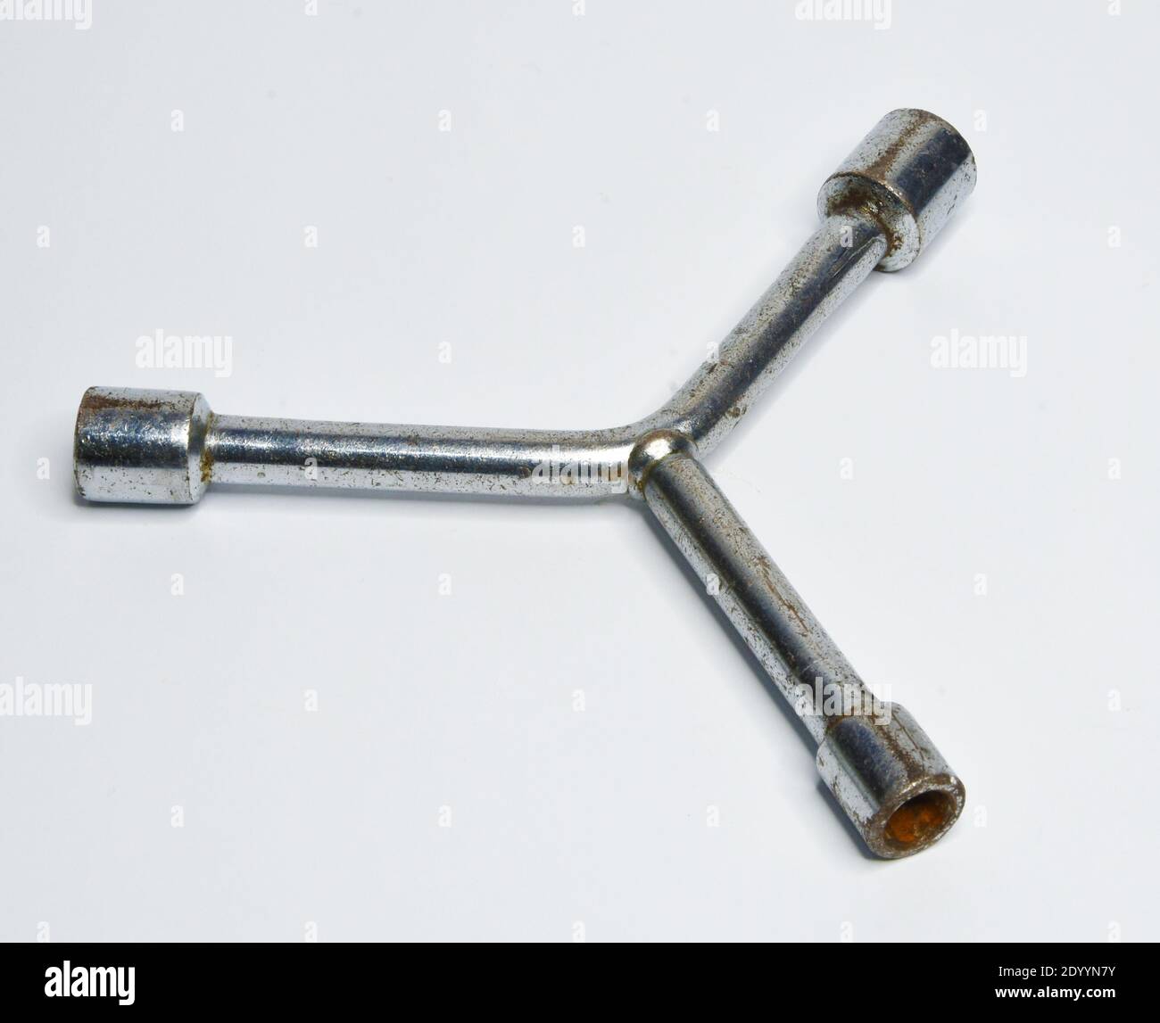 Three metal legged tool for unscrewing bolts Stock Photo - Alamy