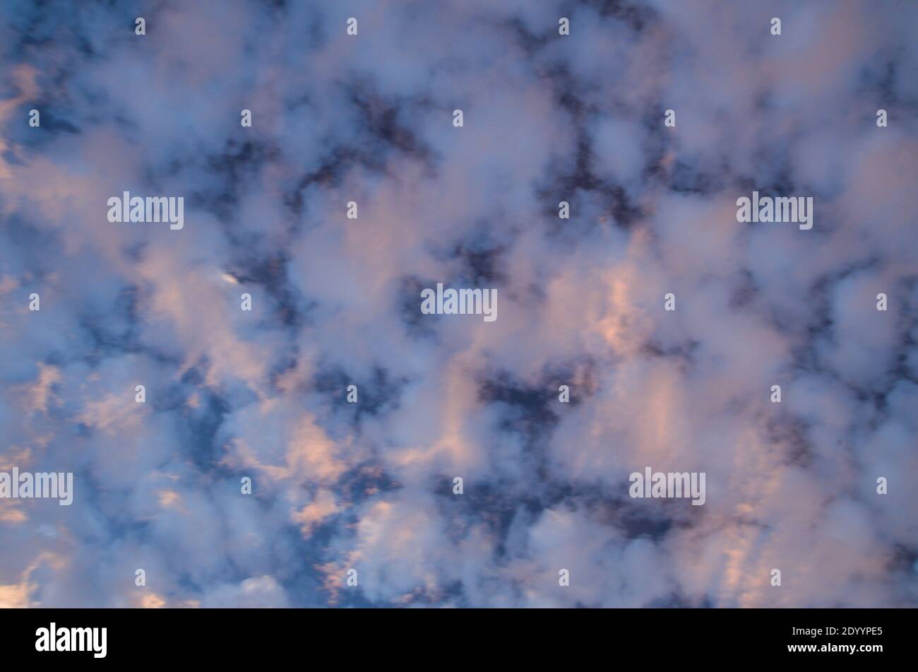Patterned Clouds with Orange Sunbeams Stock Photo - Alamy