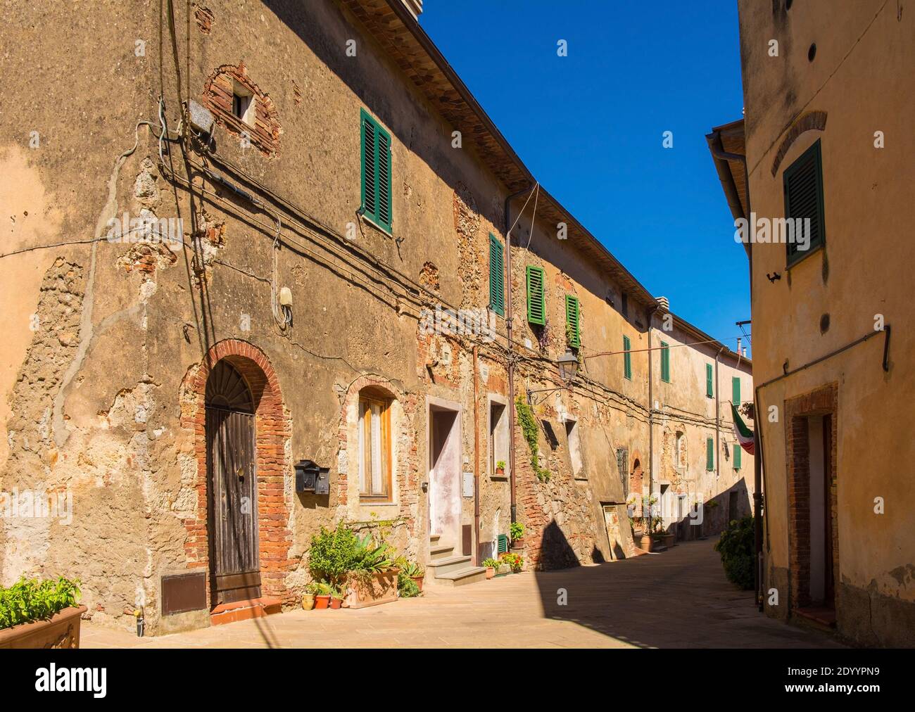 A street of historic stone buildings in the village of Montorsaio in ...