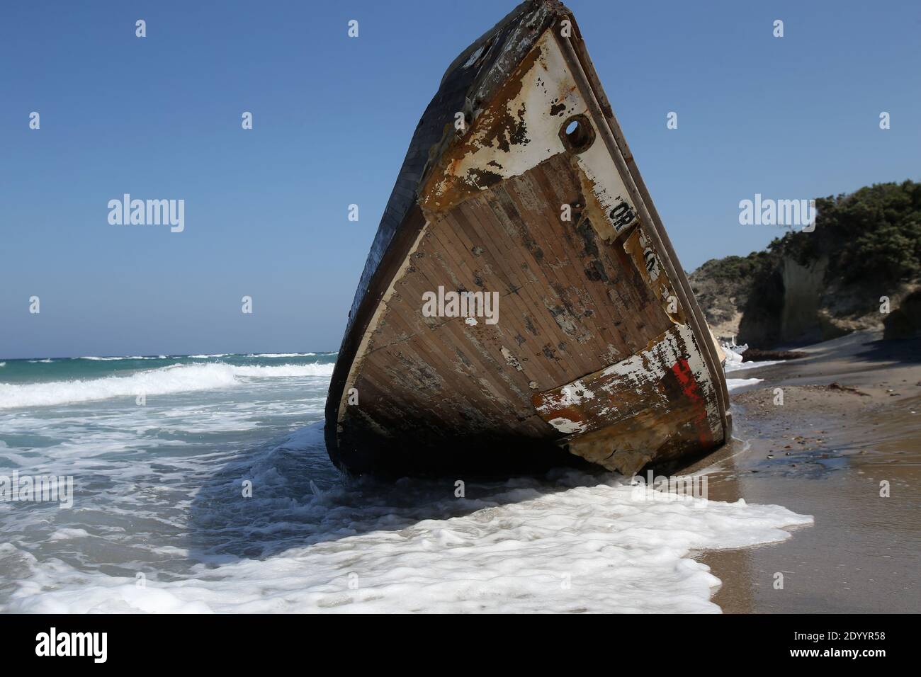 Sailboat stranded on the beach after a storm. Greece, Kos Stock Photo ...