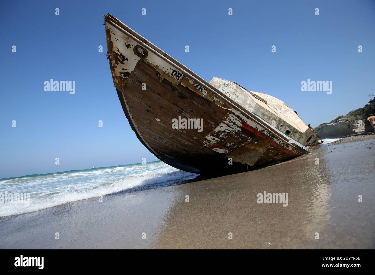 Sailboat stranded on the beach after a storm. Greece, Kos Stock Photo ...