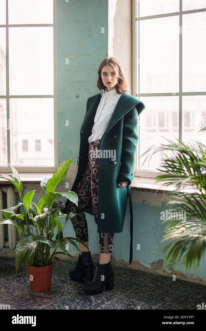 Young girl in white shirt with window behind Stock Photo - Alamy