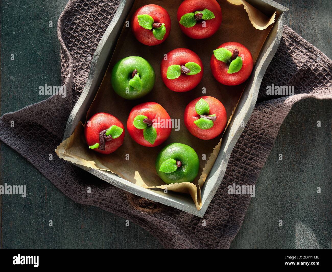 Marzipan sponge apples, green and red. Tasty creative dessert on rustic ...