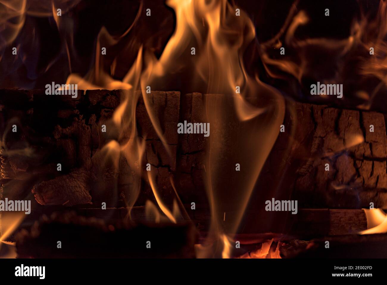 Fire flames in the fireplace. Closeup of burning wood. Heat from wood ...