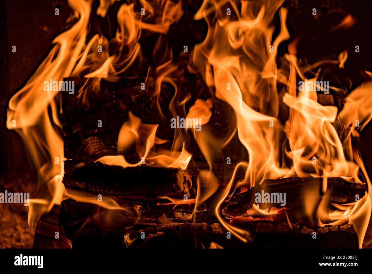 Fire flames in the fireplace. Closeup of burning wood. Heat from wood ...