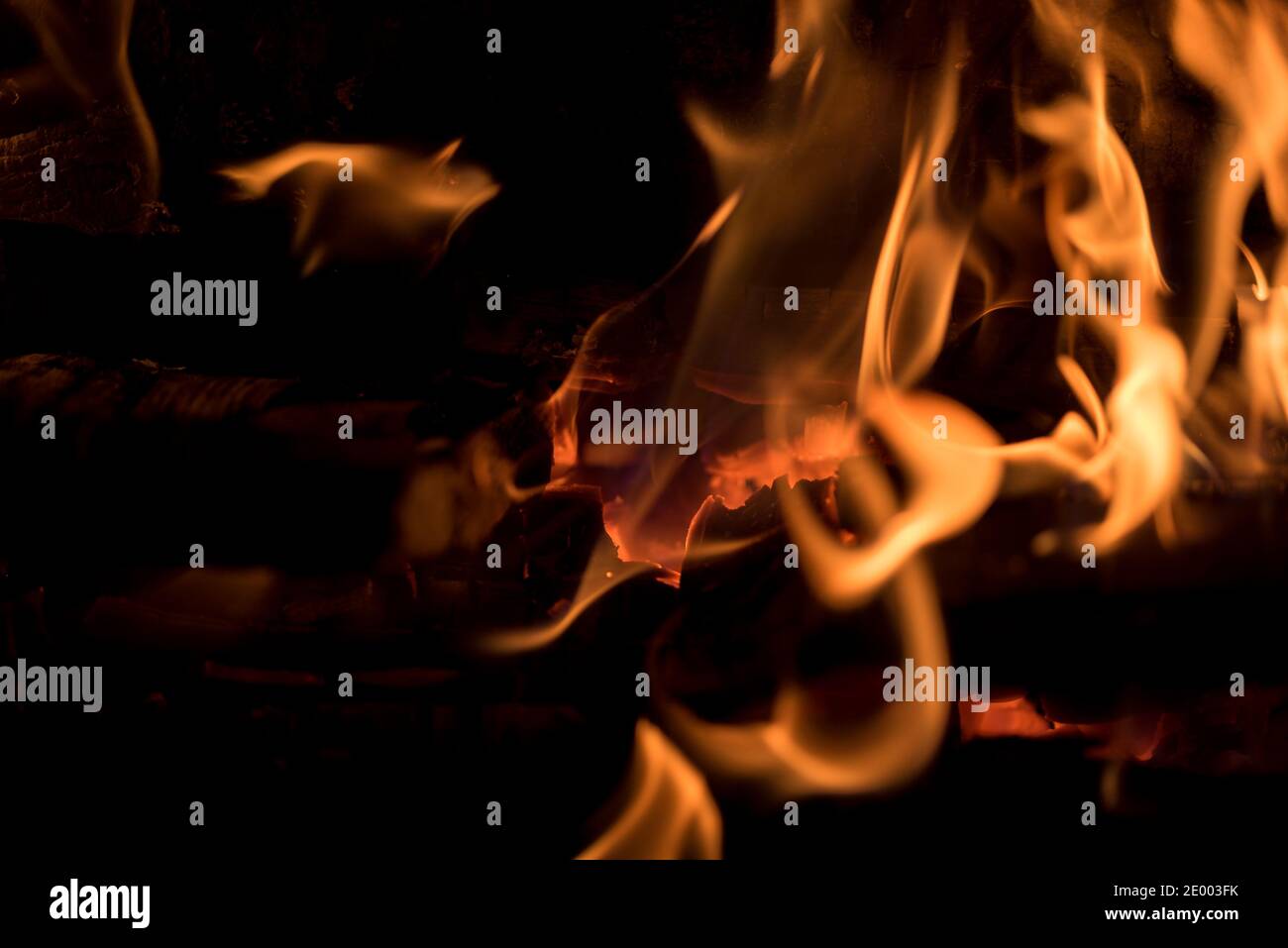 Fire flames in the fireplace. Closeup of burning wood. Heat from wood ...