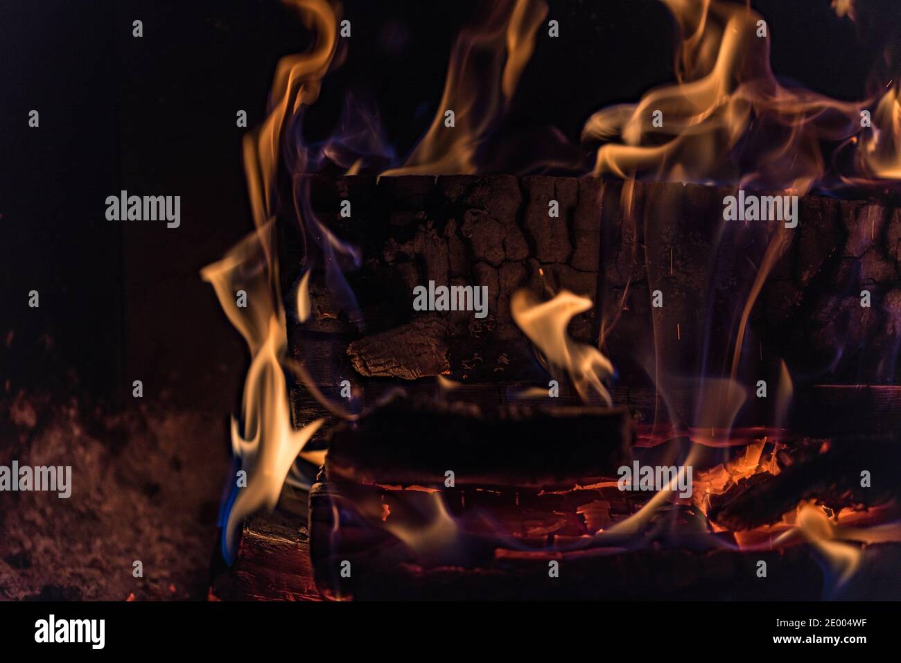 Fire flames in the fireplace. Closeup of burning wood. Heat from wood ...