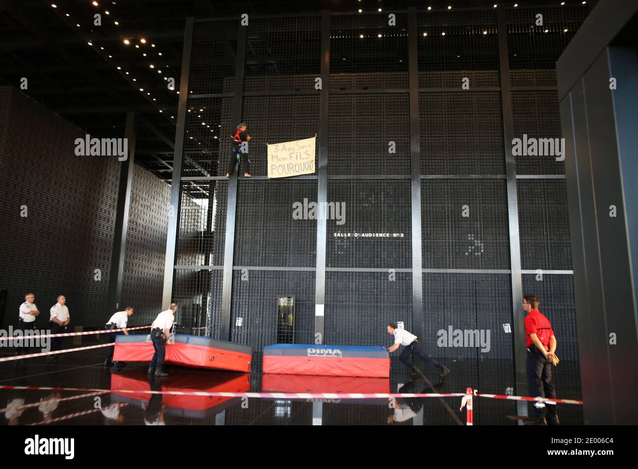 Serge Charnay stands on a wall inside the court house in Nantes, France ...