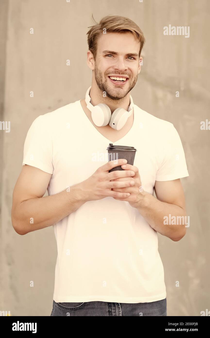 He needs caffeine energy. Happy guy hold takeaway cup outdoors ...
