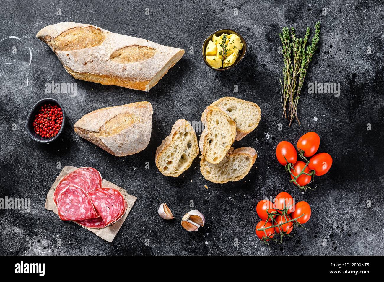 Ingredients for sandwich with butter, smoked meat, baguette, cherry ...