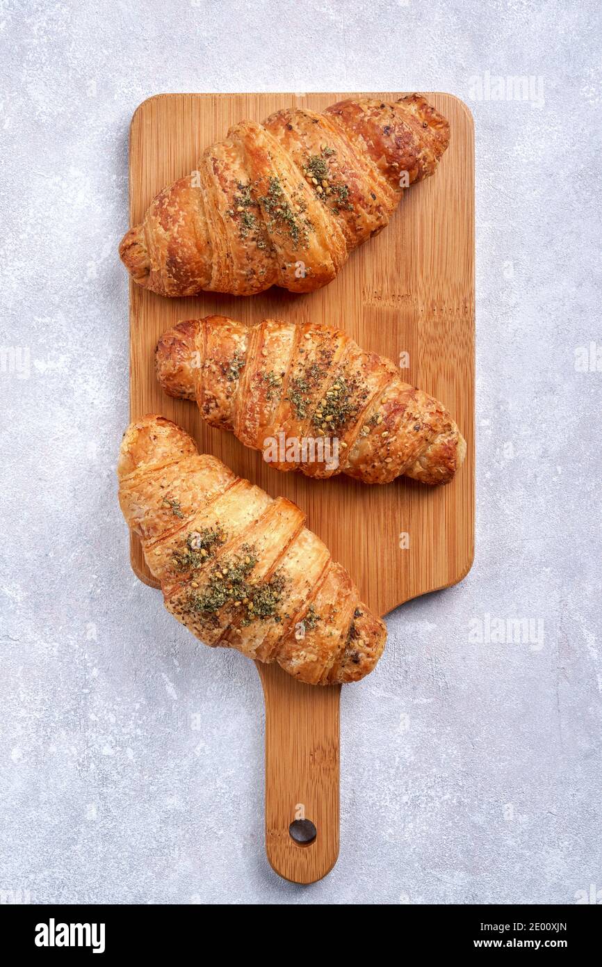 Croissants on wooden board . Top view, vertical Stock Photo - Alamy