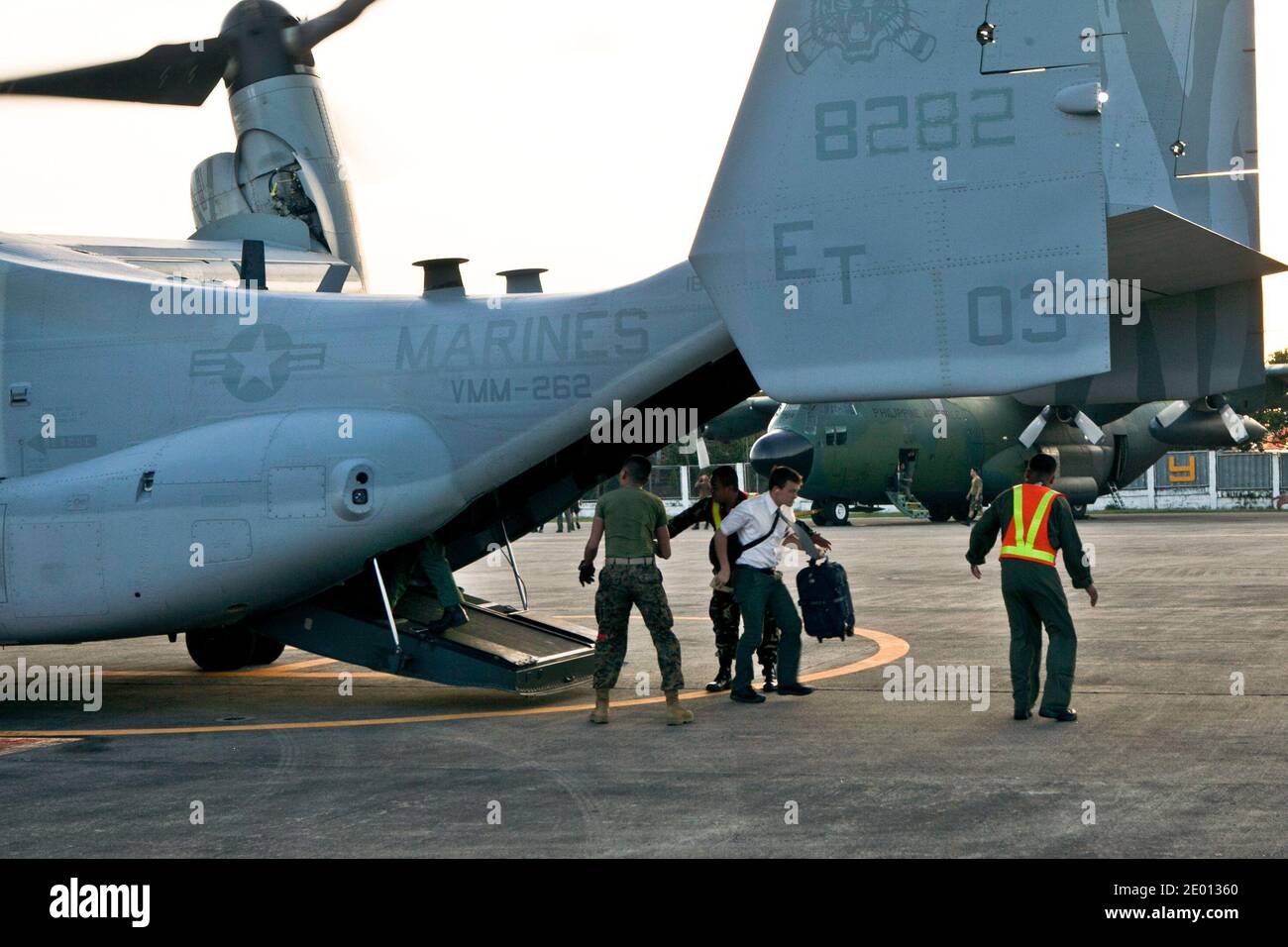 U.S. Marines guide personnel displaced by Typhoon Haiyan off an MV-22B ...