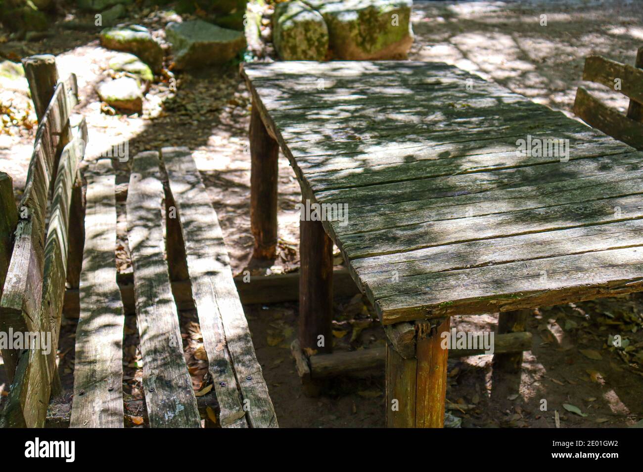 bench and wooden table in picnic area in the woods with sun rays Stock ...