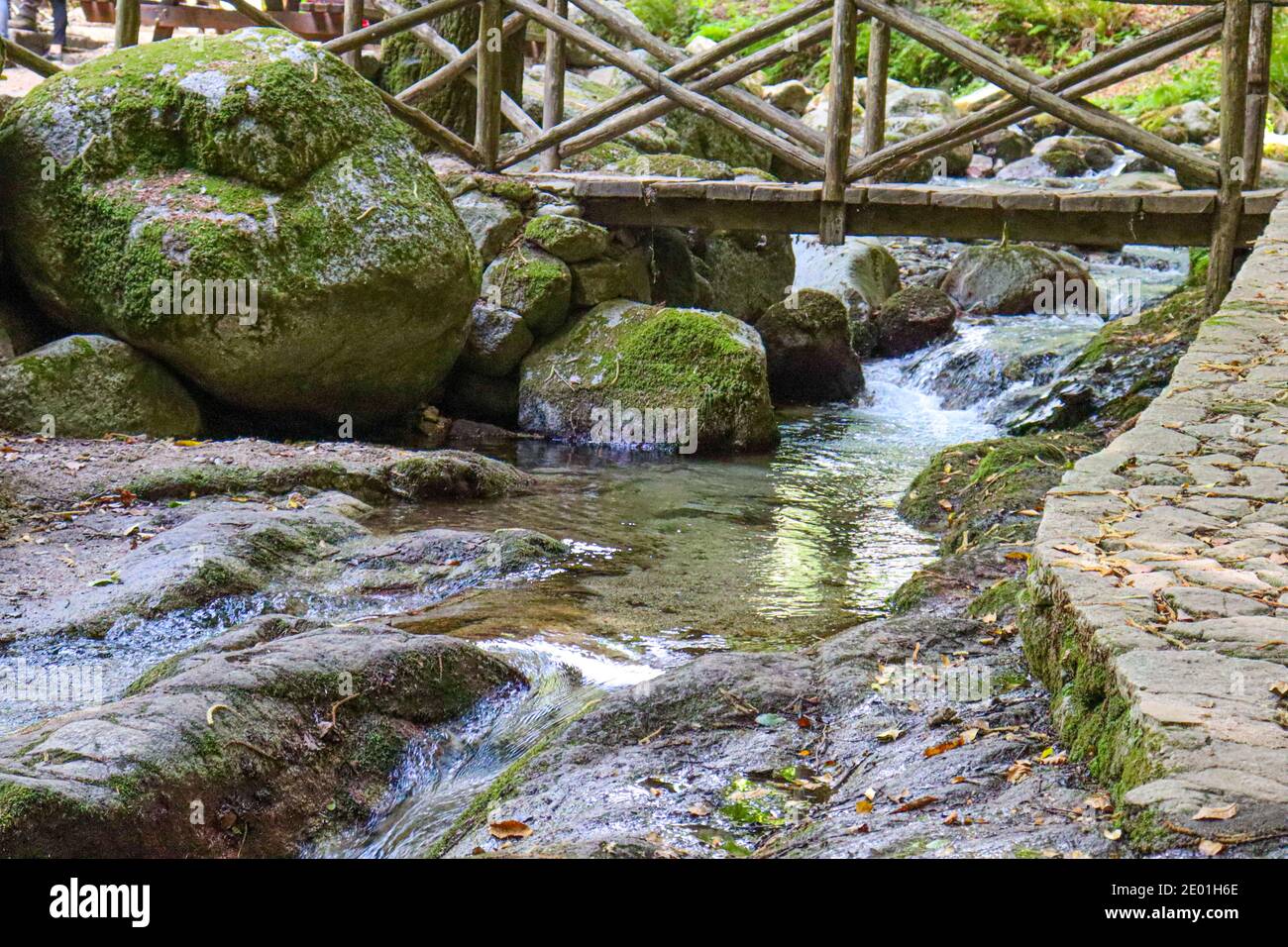 river in the mountains with stone path and wooden bridge Stock Photo ...