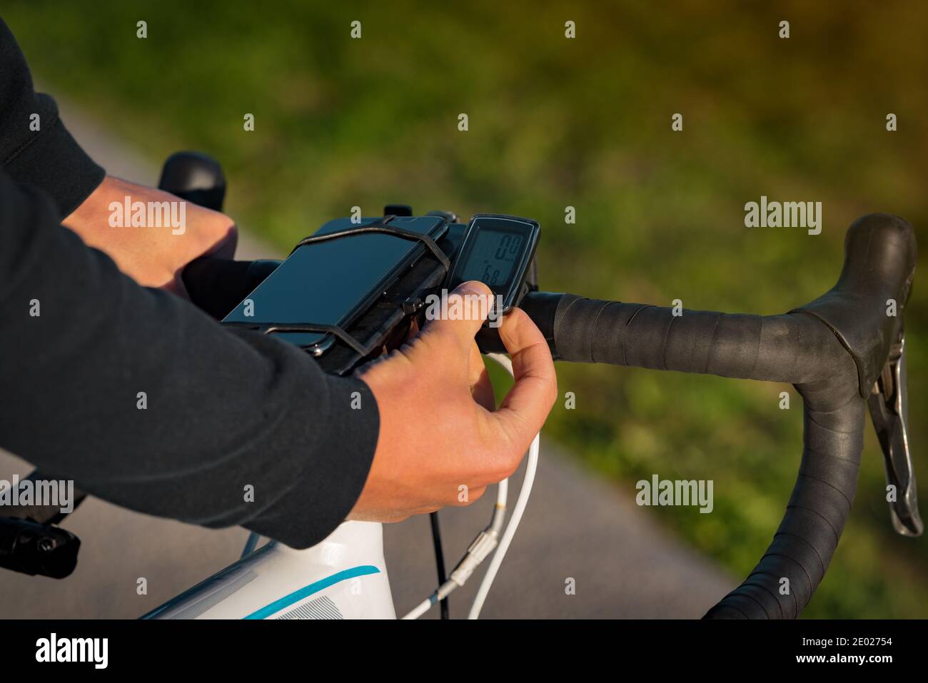 Man using bicycle speedometer. Wireless sensor for measuring speed and ...