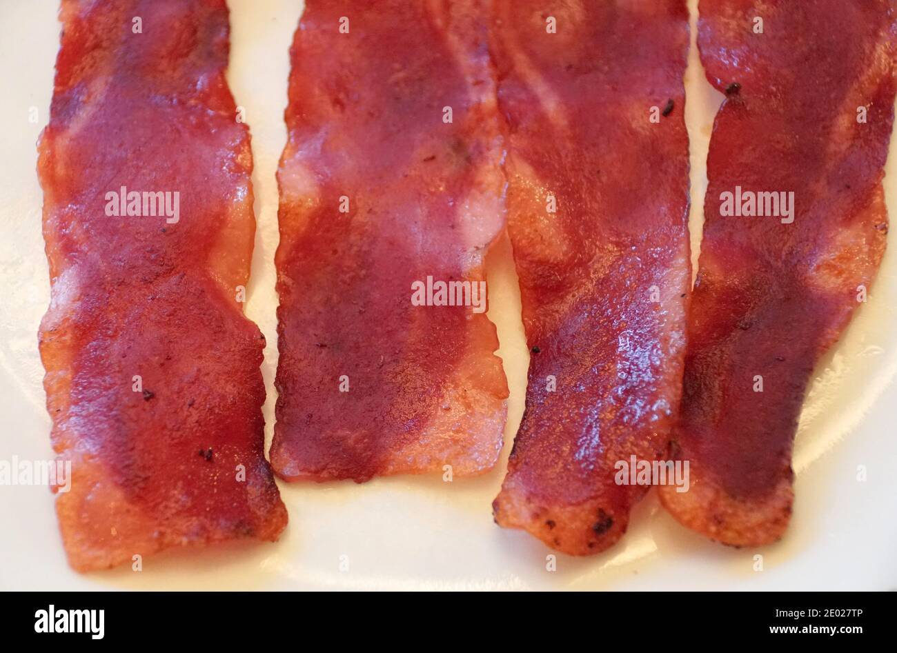Close up of crispy red turkey bacon strips on the white isolated ...