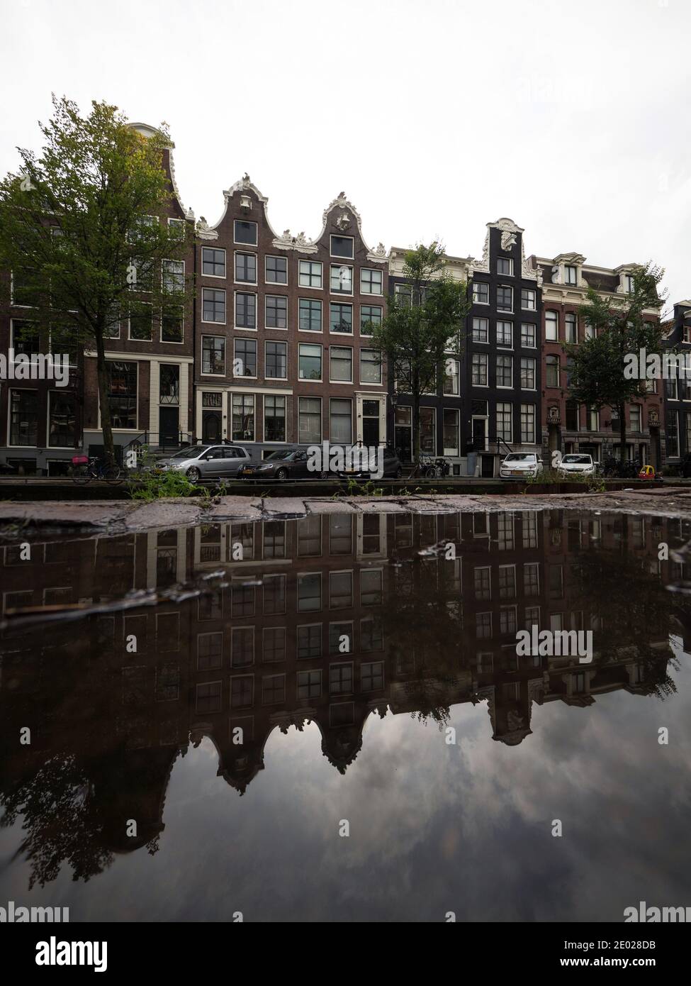Typical Amsterdam architecture street houses reflection in rain water ...
