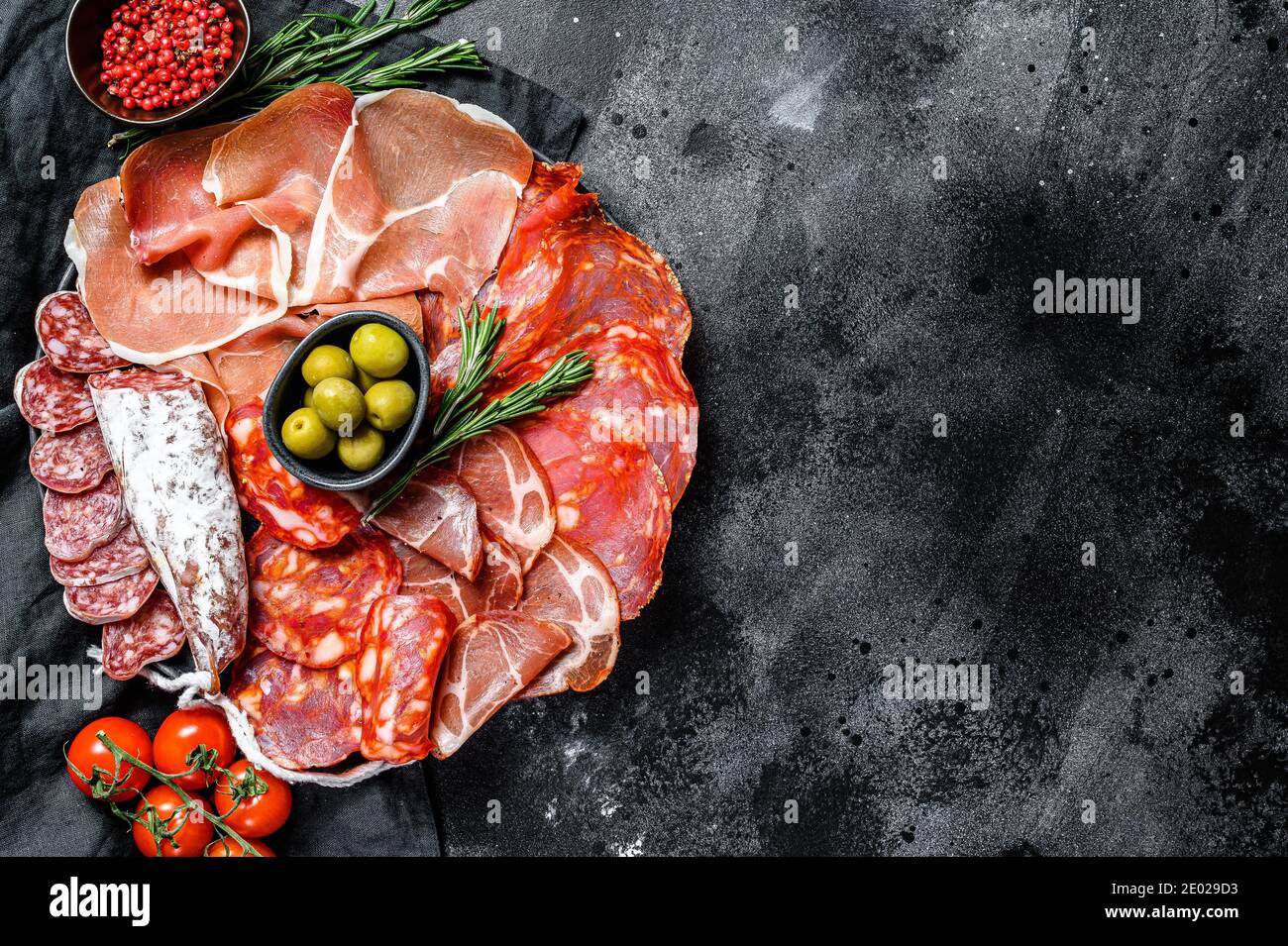 Cured meat platter of traditional Spanish tapas. Chorizo, jamon serrano ...